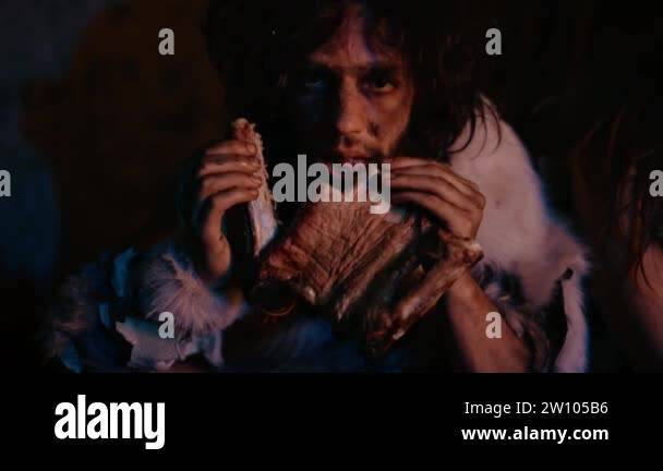 Portrait of Tribe Leader Wearing Animal Skin Eating in a Dark Scary ...