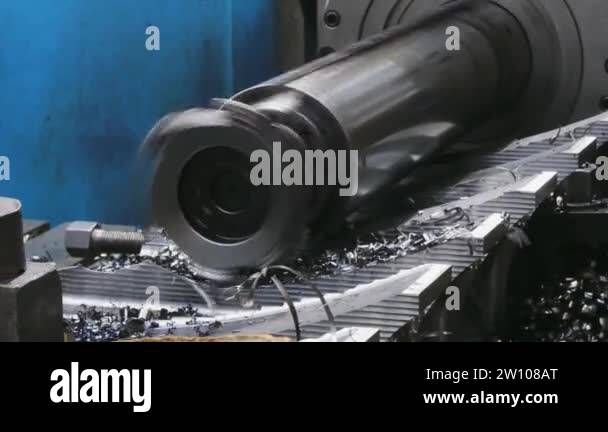 Close up of a CNC machine threading a steel roll. Twisted chips come ...