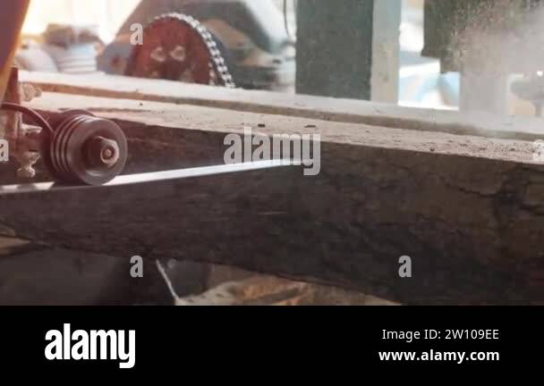 Sawing machine at wood production factory. Timber material processing ...