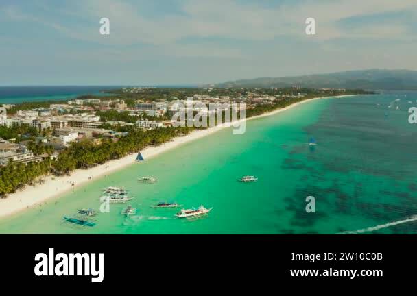 Beautiful lagoon with boats and tourist beach. White beach on the ...