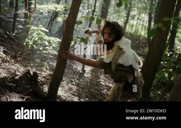 Portrait of Primeval Caveman Wearing Animal Skin and Fur Hunting with a ...