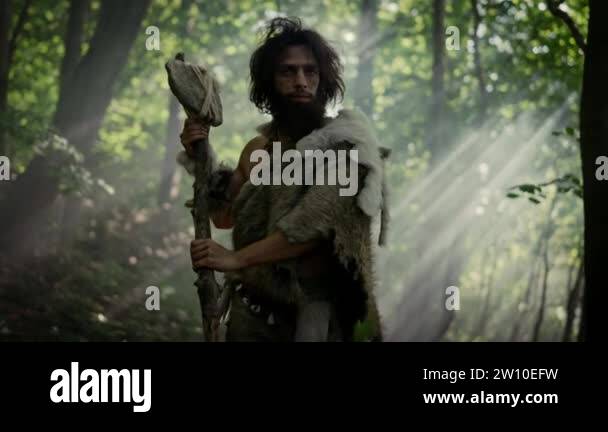Portrait of Primeval Caveman Wearing Animal Skin and Fur Hunting with a ...