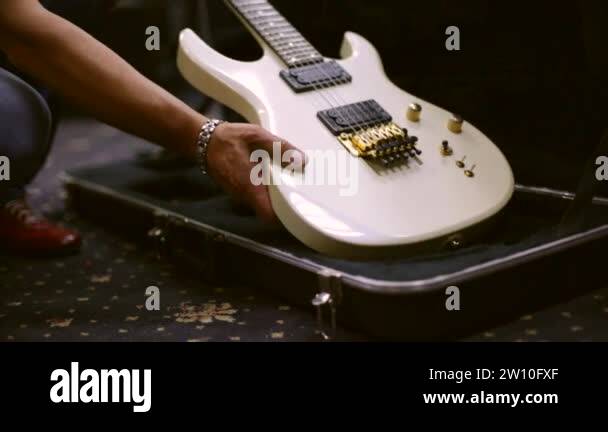 The musician pulls out and tunes an electric guitar and playing . 8 in ...