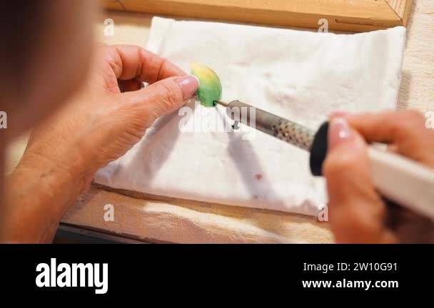 Concept of needlework, making flowers and leaves from dyed fabric ...