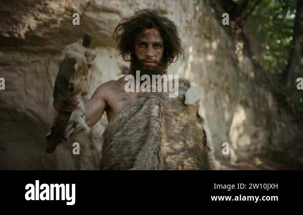 Portrait of Primeval Caveman Wearing Animal Skin Holding Stone Tipped ...