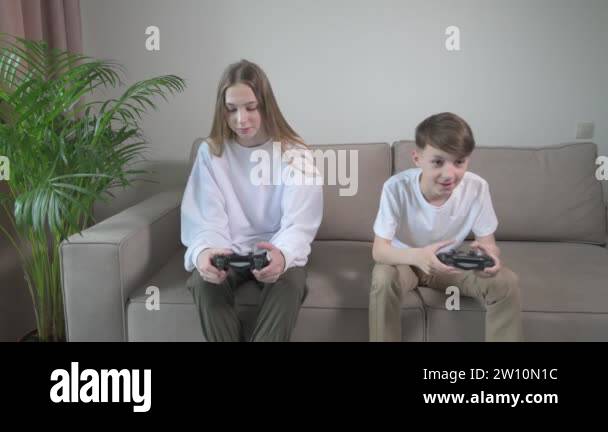 Brother and sister play with joysticks in their hands Stock Video ...