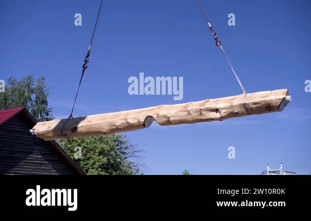 Crane lifts timber on construction site. Clip. Construction process ...