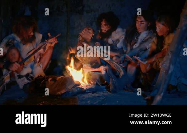 Neanderthal or Homo Sapiens Family Cooking Animal Meat over Bonfire and ...