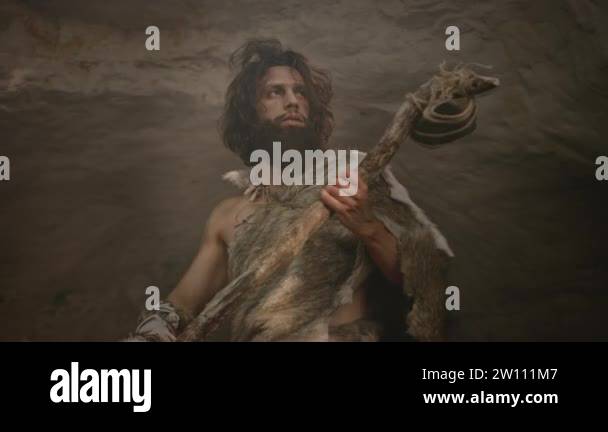 Primeval Caveman Wearing Animal Skin Holds Stone Hammer Comes out of ...