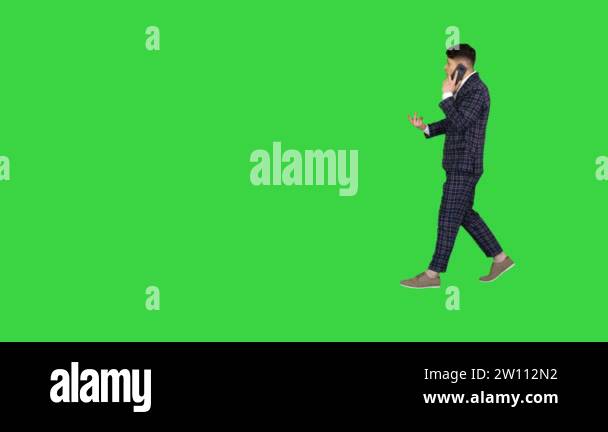 Young angry emotional man in formal suit talking on the phone and ...