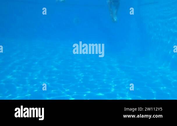 young women friends into bathing suit dives and floating underwater in ...