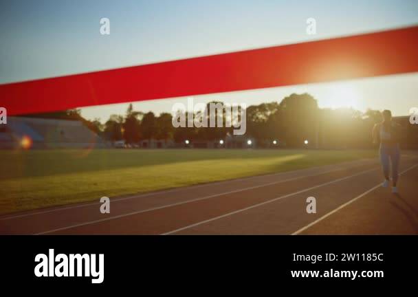 Beautiful Fit Female Runner Crossing the Finish Line on a Professional ...