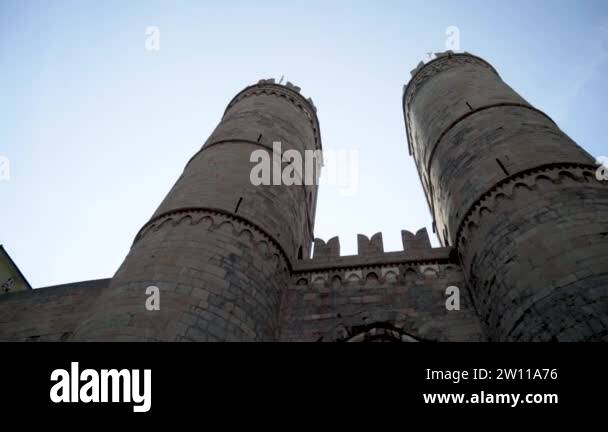 Bottom view of old fortress towers. Action. Two towers of old castle ...