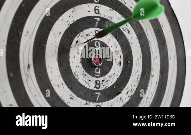 Throwing three darts into the target aim and missing a ten points ...