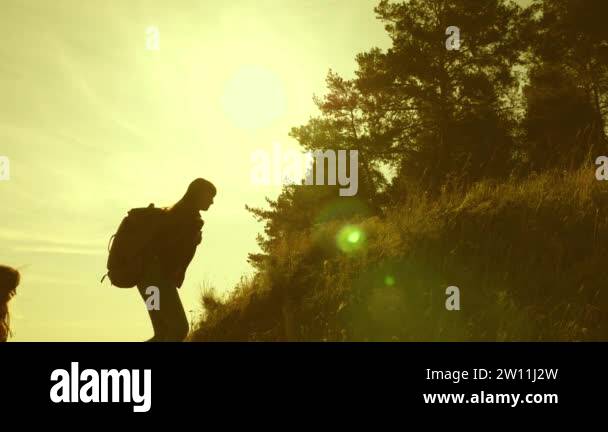 Traveler girls climb mountain, offer each other a helping hand, helping ...