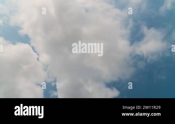 Building motions clouds. Puffy fluffy white clouds sky time lapse. slow moving clouds. B Roll ...