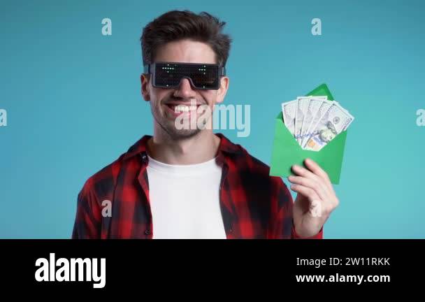 Happy european man in glowing with dollar signs glasses showing money ...