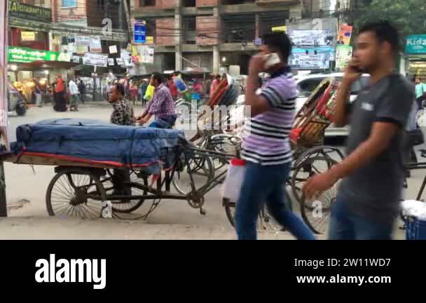 Unidentified people and street traffic at the Ring Road in the Adabor ...