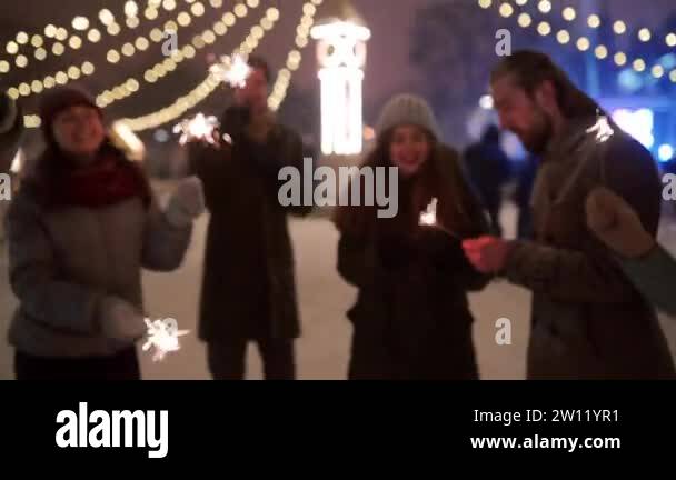 Friends have fun partying with sparklers and explode confetti cannon at ...