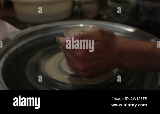 The master creates a white clay product. The master's hands close-up ...