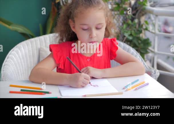 Cute small little girl artist playing alone drawing coloring picture ...