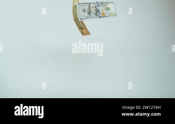 Rain of dollar banknotes. Dollar banknotes are falling in slow motion ...