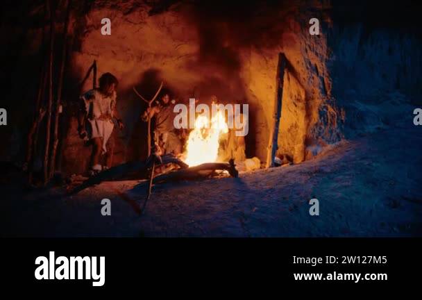 Tribe of Prehistoric Hunter-Gatherers Wearing Animal Skins Stand Around ...