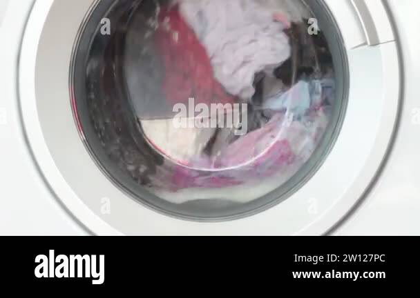 washing machine working with rotating garments inside, process of ...