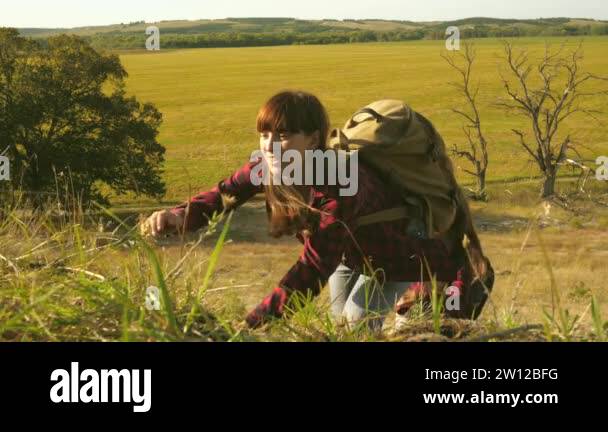 travelers teamwork. tourist with backpacks help climb each other up the ...