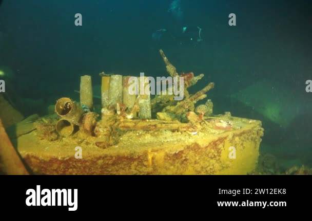 Diver inside hull of sunken ship underwater of Pacific Ocean on Chuuk ...