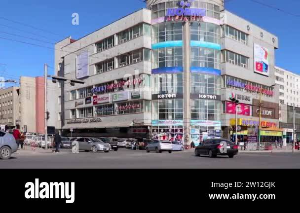 Street traffic at the Nomin Plaza, a large department store in Ulaanbaatar, the capital of ...