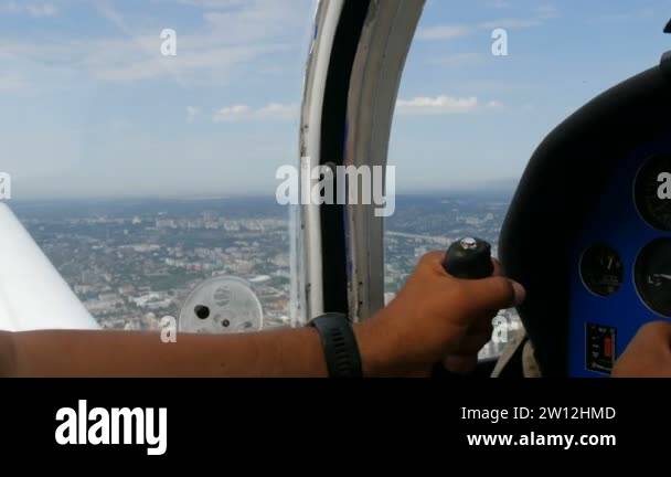 The hands of a professional pilot hold the helm and control panel of an ...