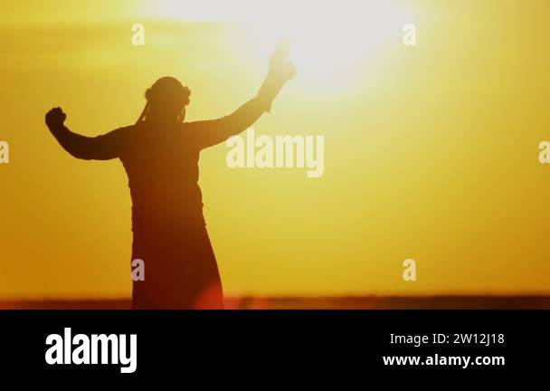 Islamic warrior with Kalashnikov at sunset day. Muslim fighter is ...