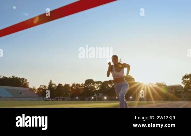 Beautiful Fit Female Runner Crossing the Finish Line on a Professional ...