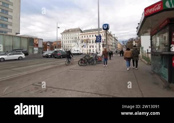 Vienna city streets people pass by with an coca cola commercial on a ...