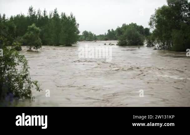 Natural disaster . Fast flowing raging river. Soil and mud is moving ...