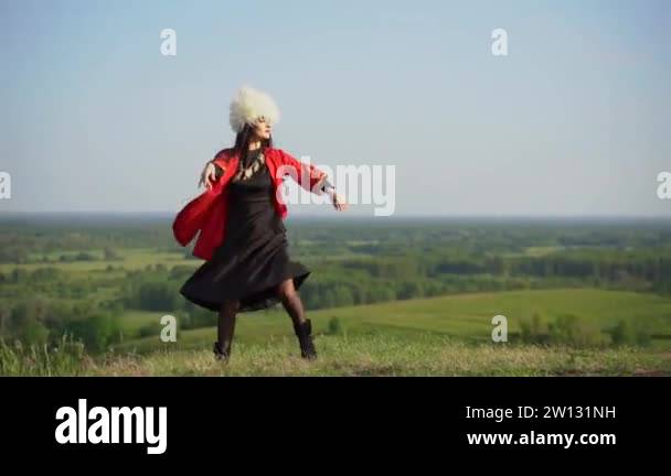 Georgian girl in white papakha and red national dress dances national ...