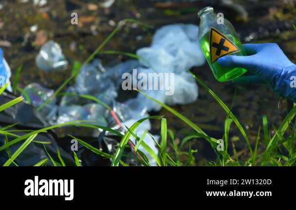 Person pouring forbidden liquid in polluted water, waste after lab ...
