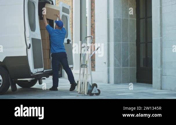 Delivery Man Uses Hand Truck Trolley with Cardboard Boxes, Packages ...