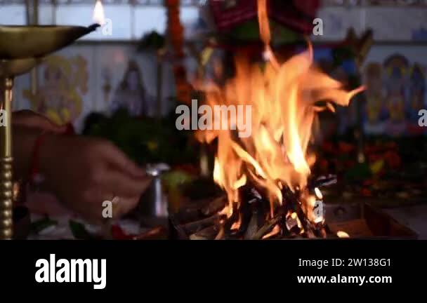 Panditji doing the Havan or yogga pooja. A pooja thali with some lamp ...
