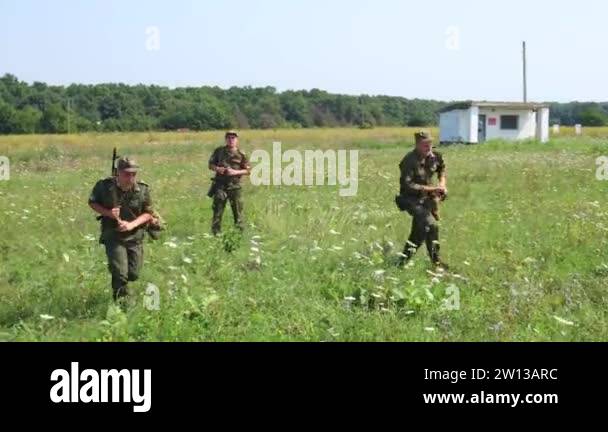 MOSCOW - JULY 30. Soldiers shoot from an AK-47 machine gun at targets ...