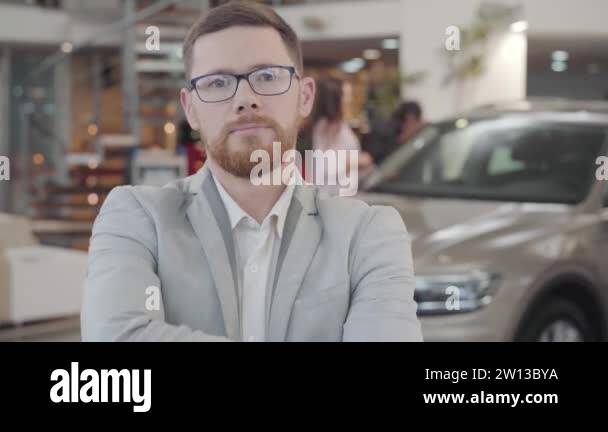 Close-up face of young Caucasian car dealer gesturing yes by shaking ...