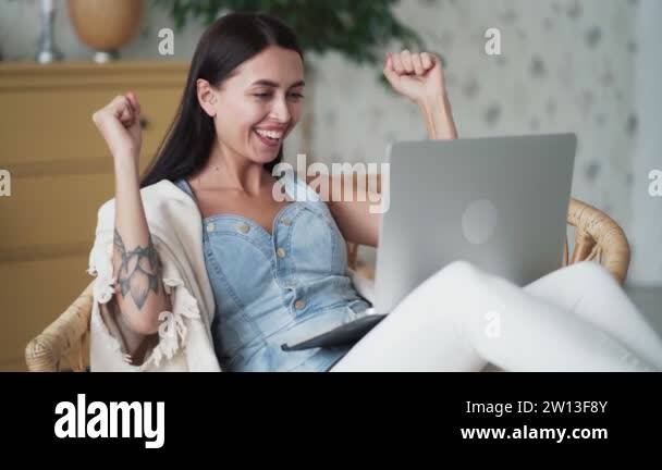 Woman looks at laptop computer excited by great professional work ...