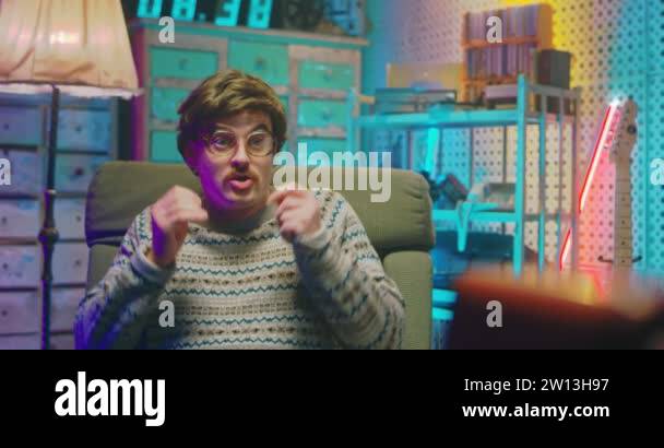 Caucasian afraid young man nerd in glasses and with mustache sitting in ...