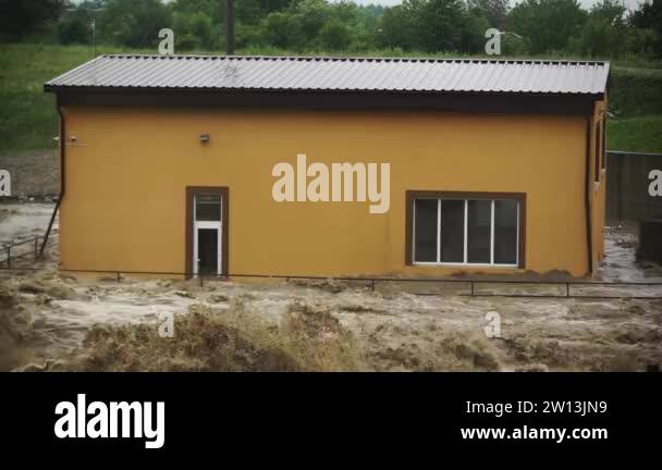 Natural disaster . Fast flowing raging river. Soil and mud is moving ...