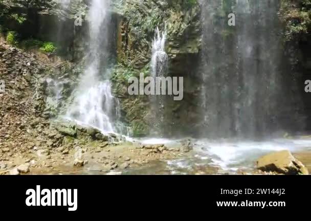 Beautiful waterfall falling down the mountainside in the majestic Grand ...