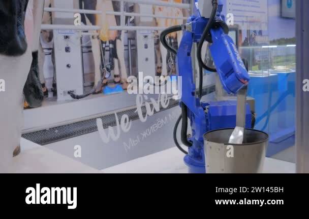 Automatic milking robot arm machine at cattle dairy farm, trade show ...