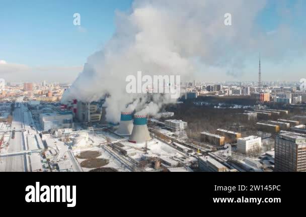 Smooth aerial shot around industrial factory chimney, dense fume comes ...