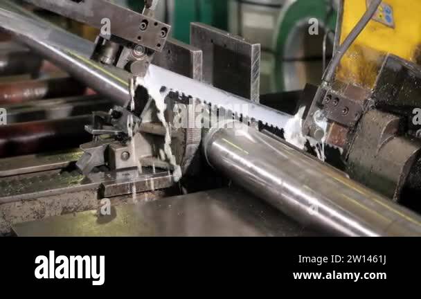The industrial sawing machine cutting the material rod. The band saw ...