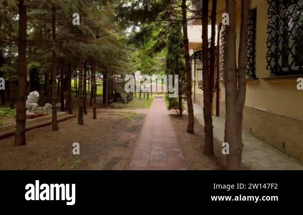 Courtyard with antique style sculptures near old historic residential ...